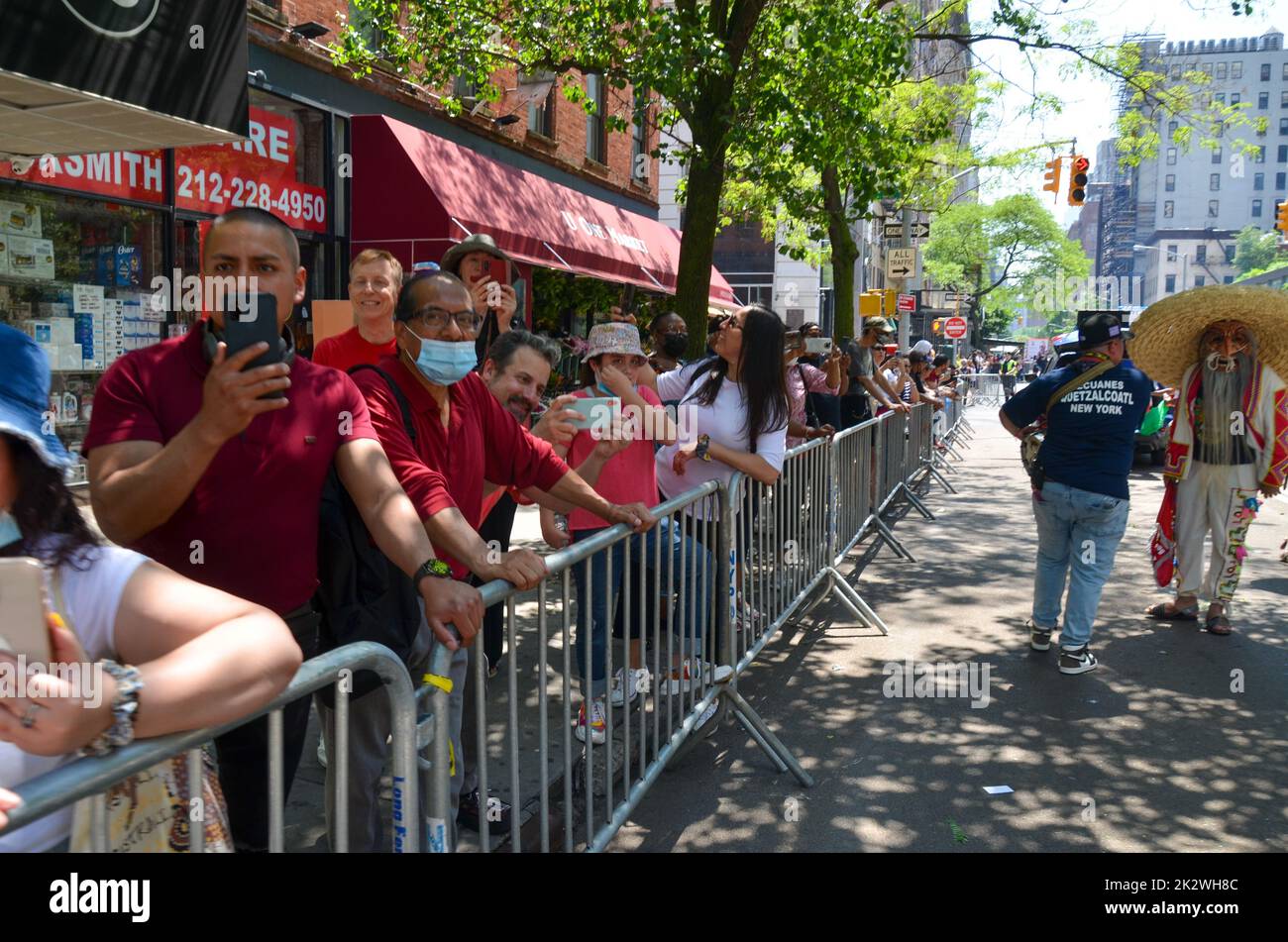 Many watchers recording scene of the festival behind metal fences of ...