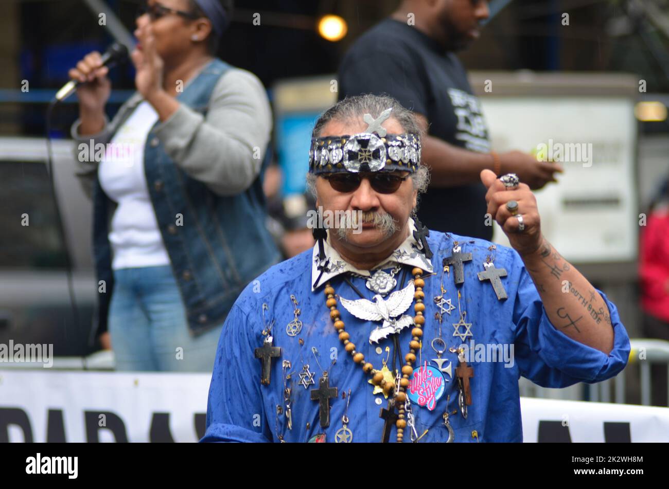 A cool man with religious cross signs on his shirt in the festival of ...