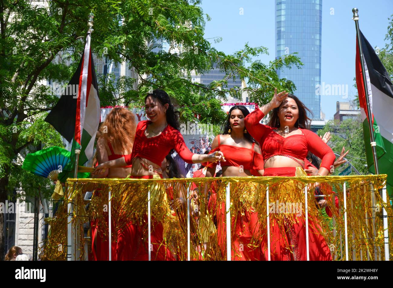 A group of girls in red dress dancing in Annual Dance Parade along ...