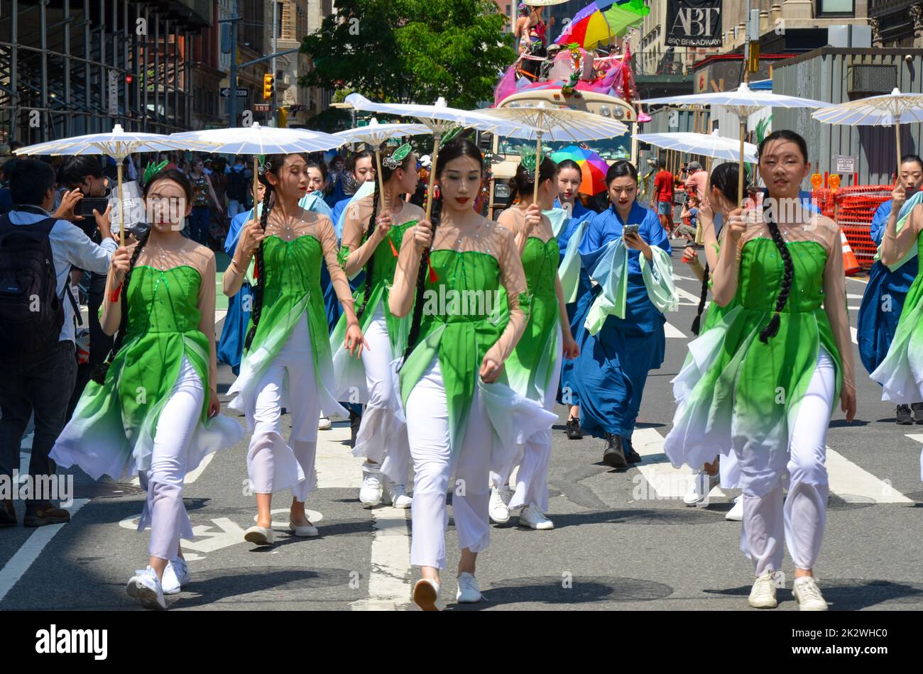 Beautiful girls in traditional dresses walking on street during Annual ...