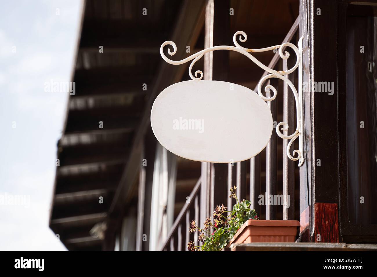 Horizontal front view of empty round metal signage on a building with ...