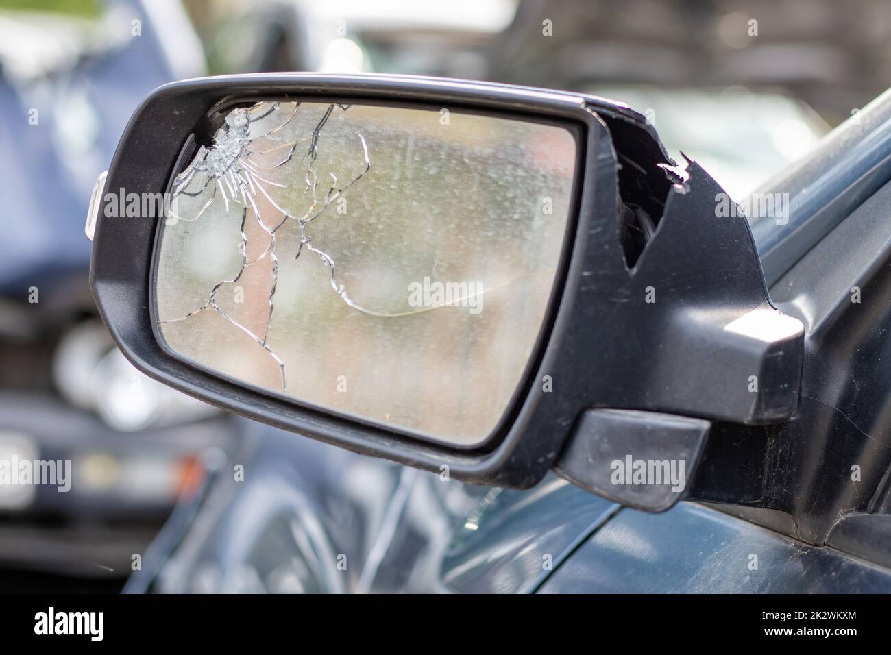 Close up broken left side rearview mirror of a car in blue. Auto ...