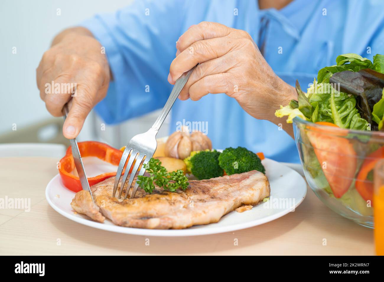 Asian senior or elderly old lady woman patient eating breakfast and ...