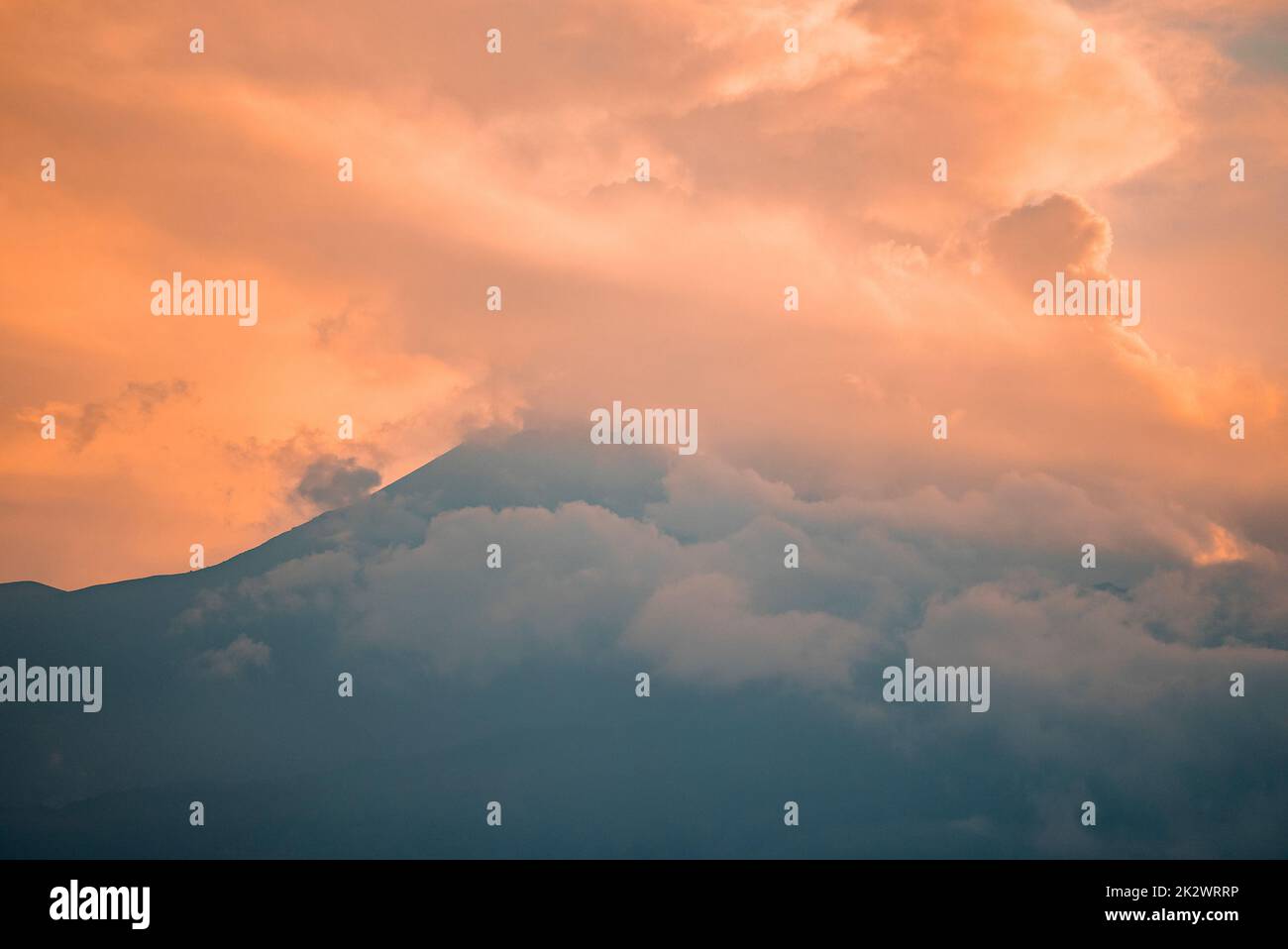 Scenic view of famous Mount Etna covered with clouds and smoke during ...