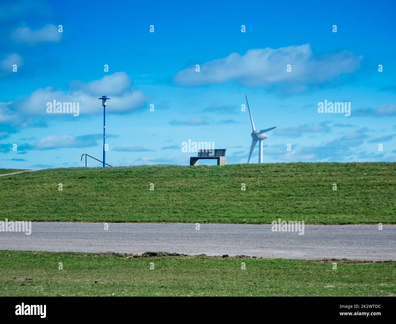 Bench lantern and wind turbine on the dike Stock Photo - Alamy