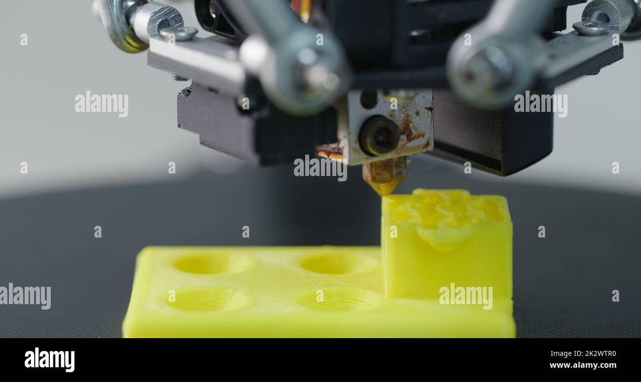 3D Printing Machine printing a piece of plastic Stock Photo - Alamy