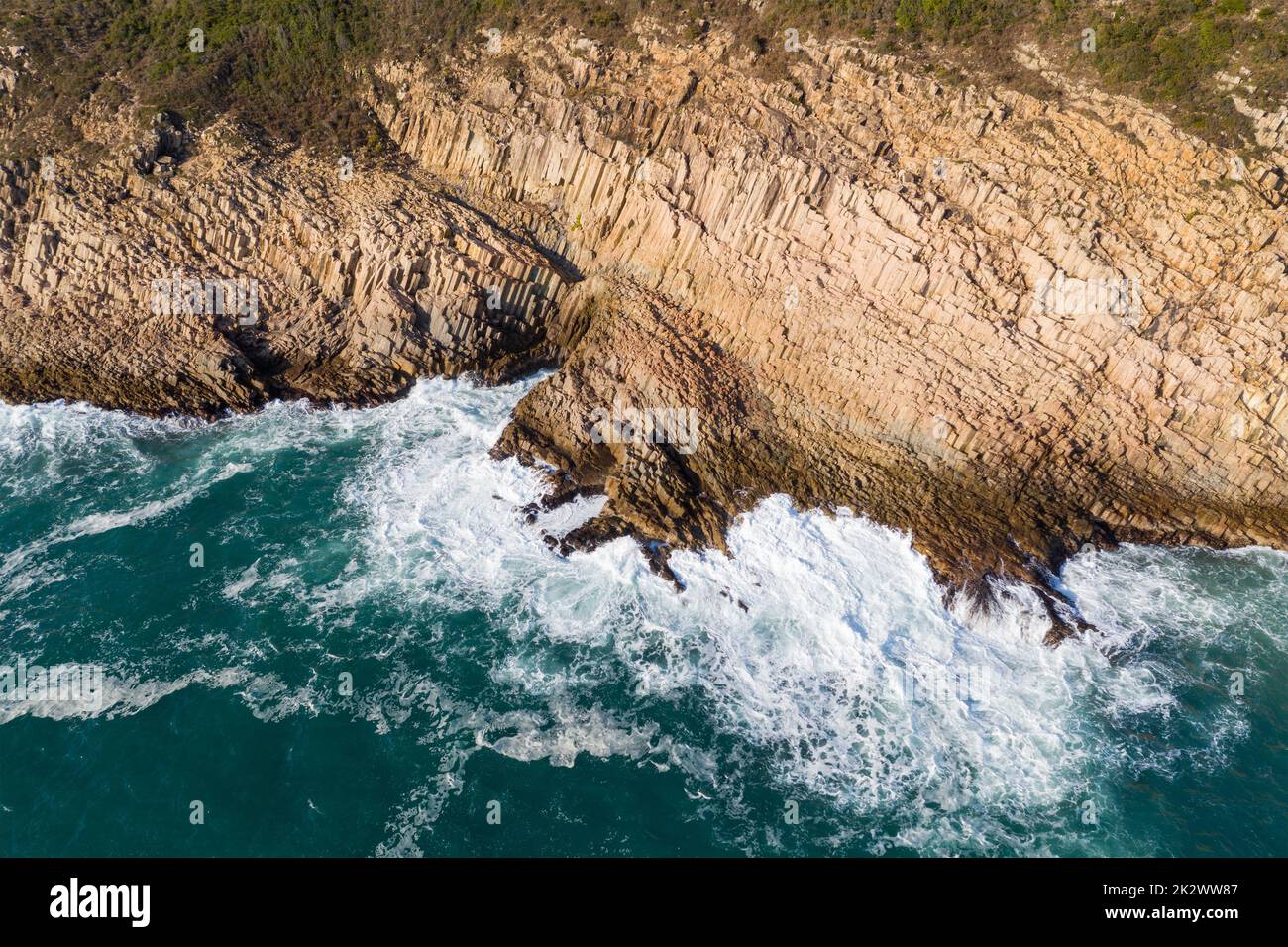 Ocean waves splash against rock on island Stock Photo - Alamy