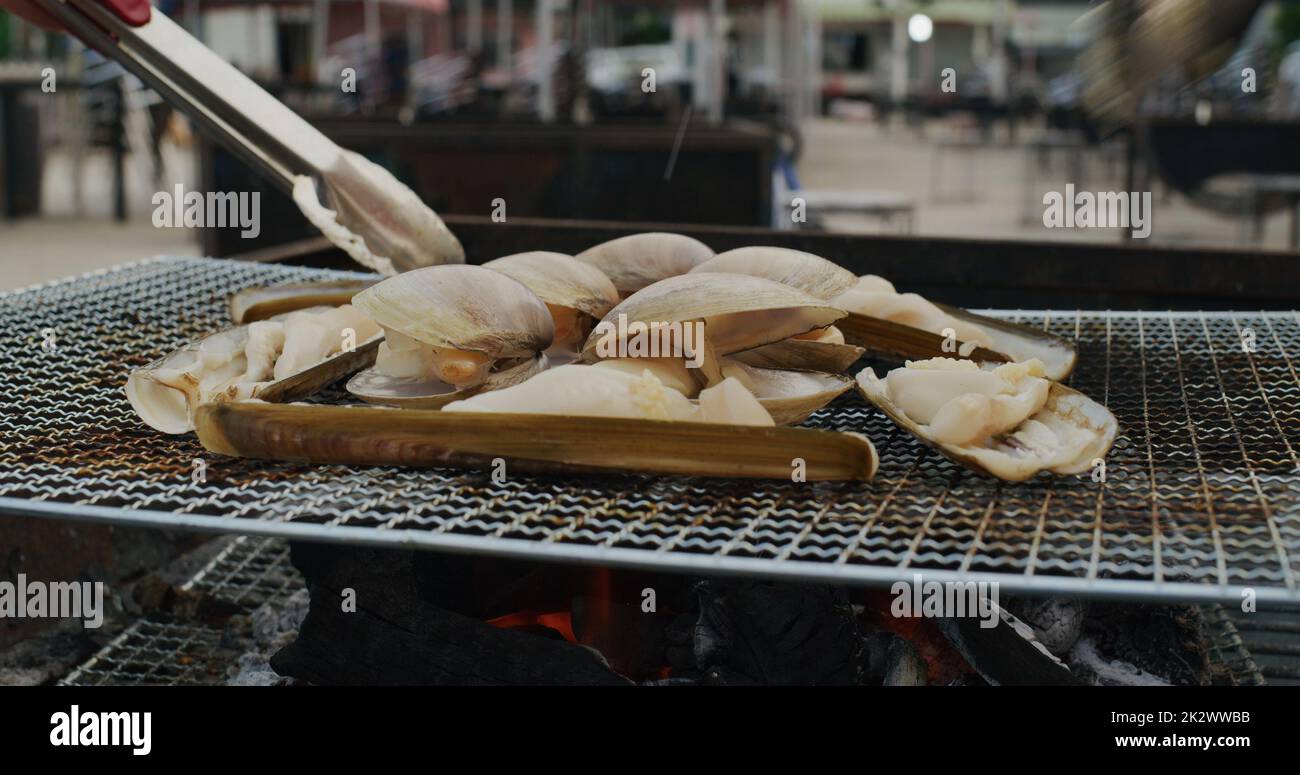 Fresh Short necked clam and Razor Clam on barbecue net Stock Photo - Alamy