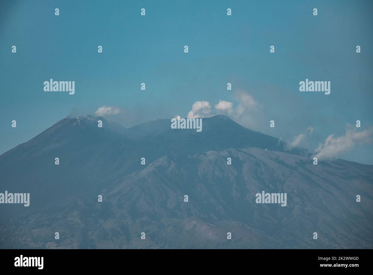 Beautiful volcanic Mount Etna with blue sky in background during summer ...