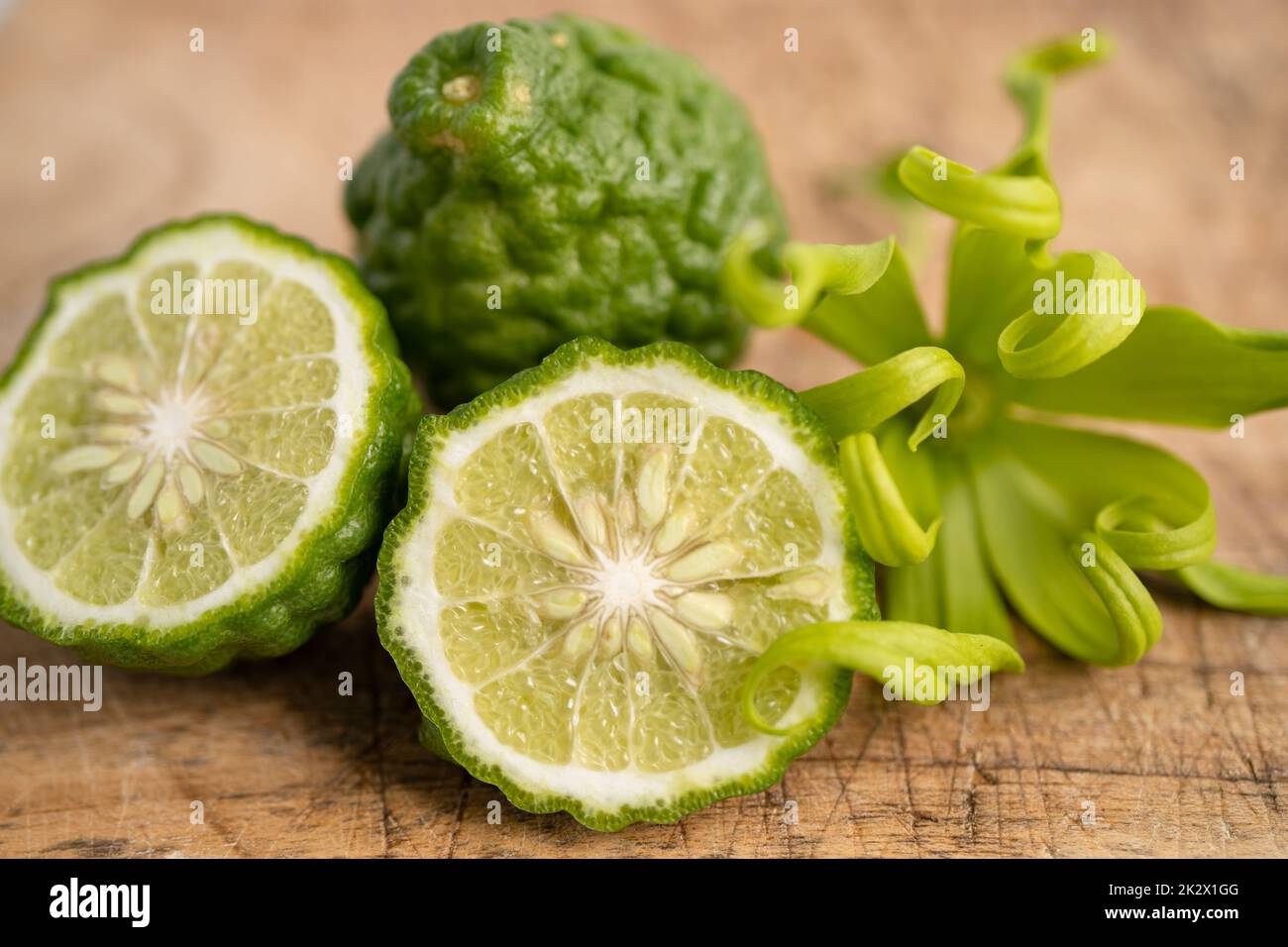 Fresh bergamot fruit with cut in half on wooden background Stock Photo ...