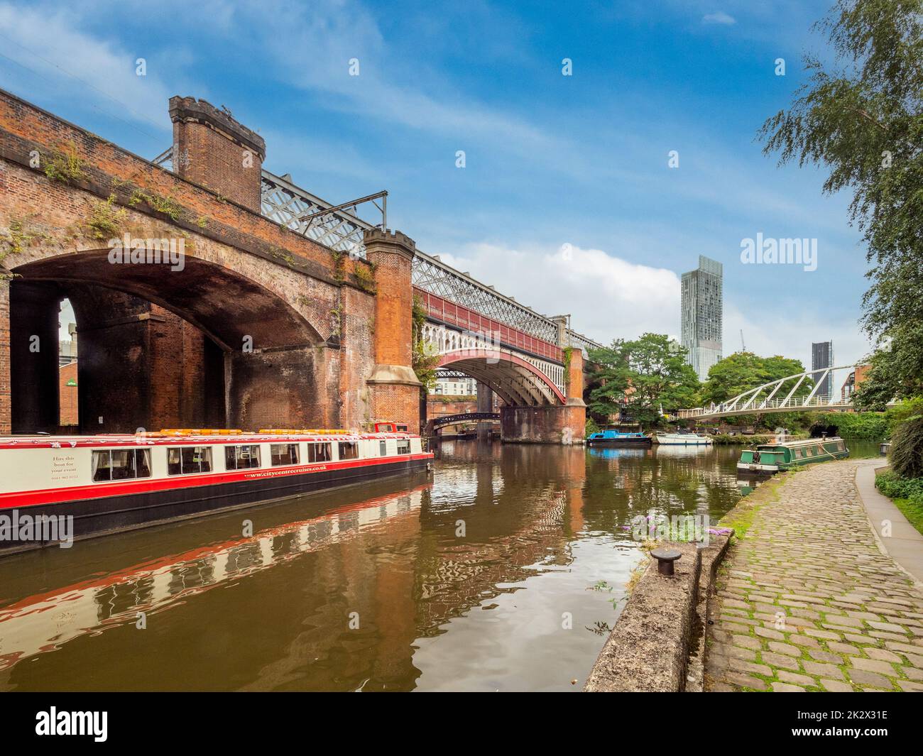 Moored barges alongside the Bridgewater viaduct with Beetham Tower in ...