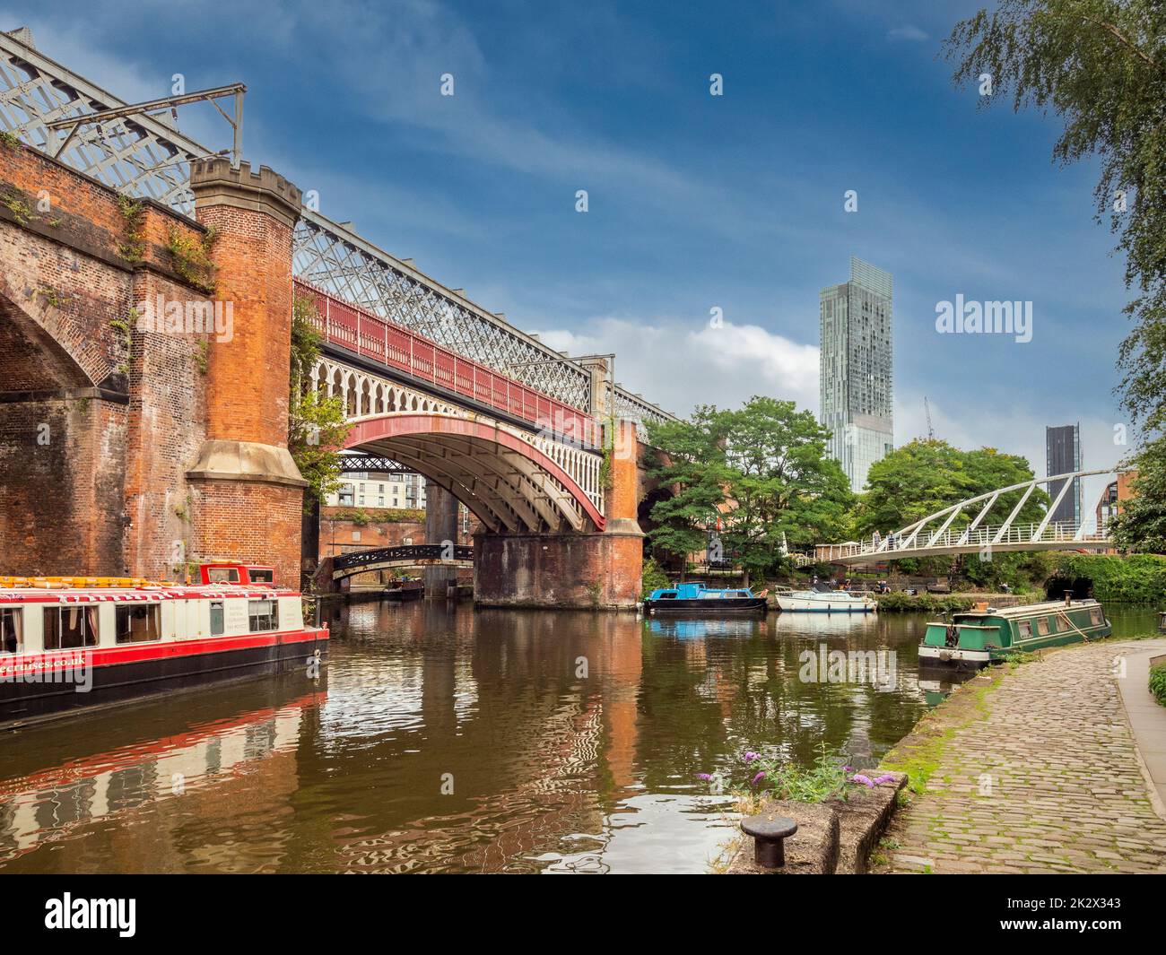 Moored barges alongside the Bridgewater viaduct with Beetham Tower in ...