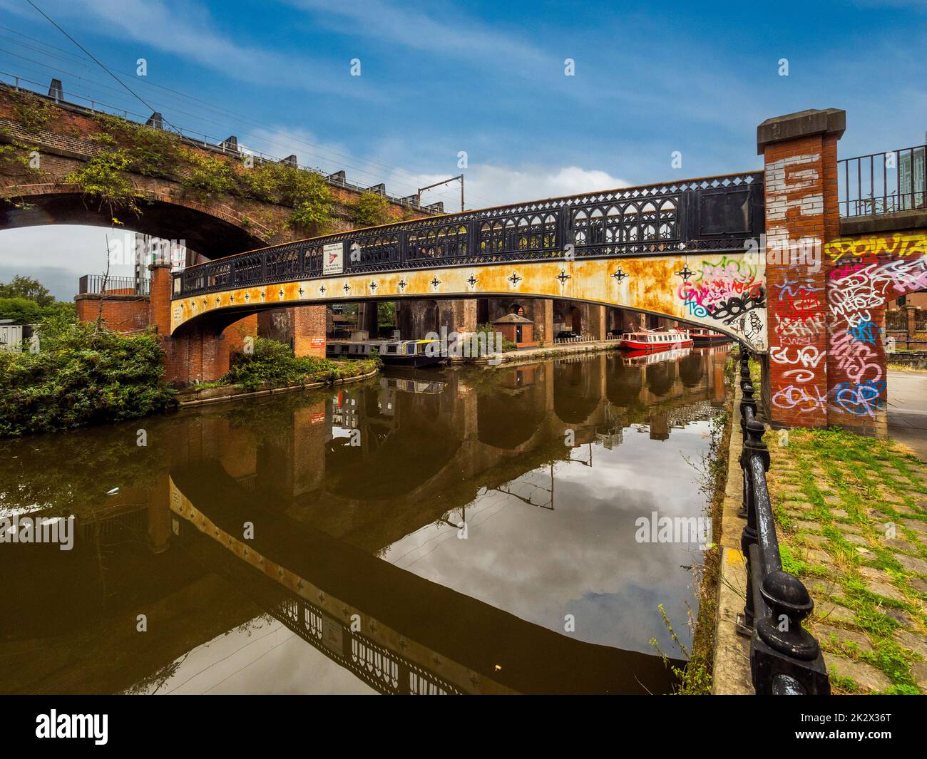 Footbridge, with brightly coloured graffiti spanning the Bridgewater ...