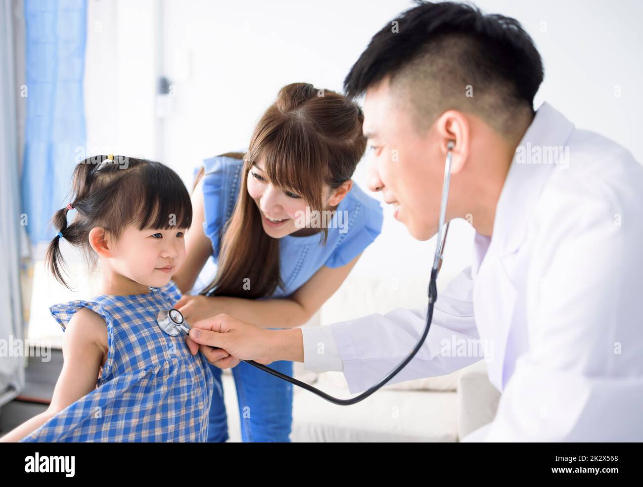 Male pediatrician hold stethoscope exam child girl patient visit doctor ...