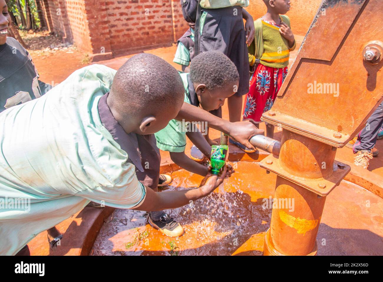 Kids in different age were trying to collect some drinking water in ...