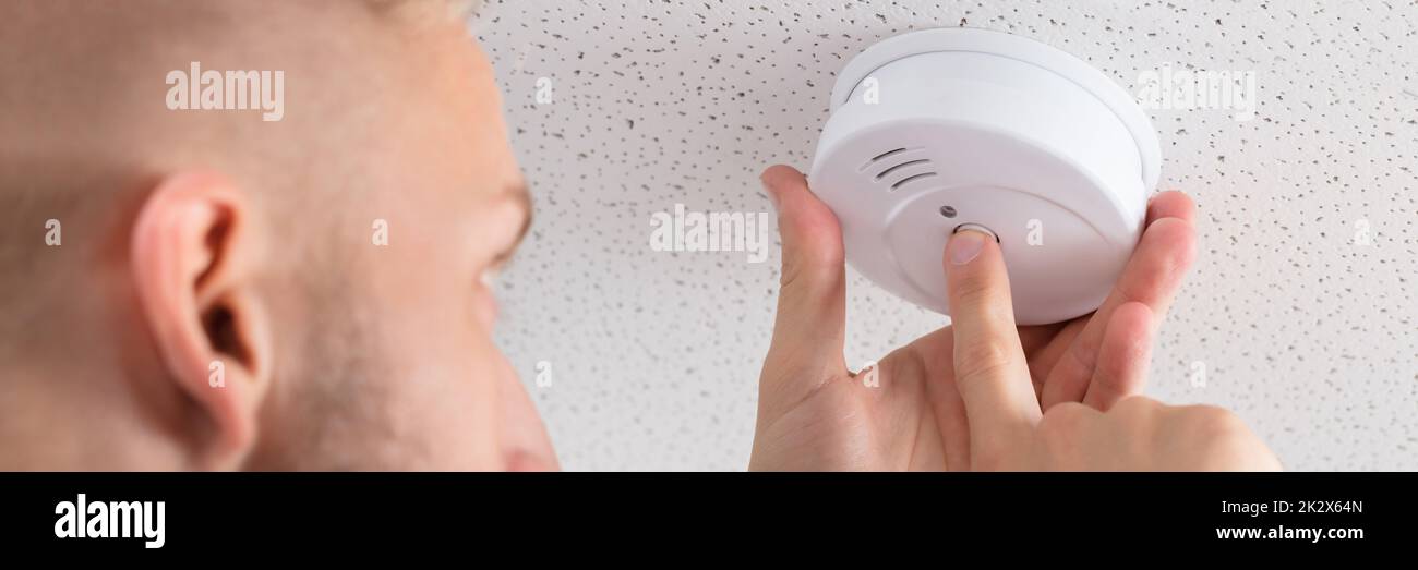 Person's Hand Installing Smoke Detector On Ceiling Stock Photo - Alamy