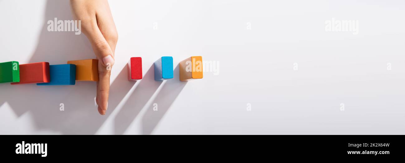 Businessperson Hand Stopping Colorful Blocks From Falling Stock Photo ...
