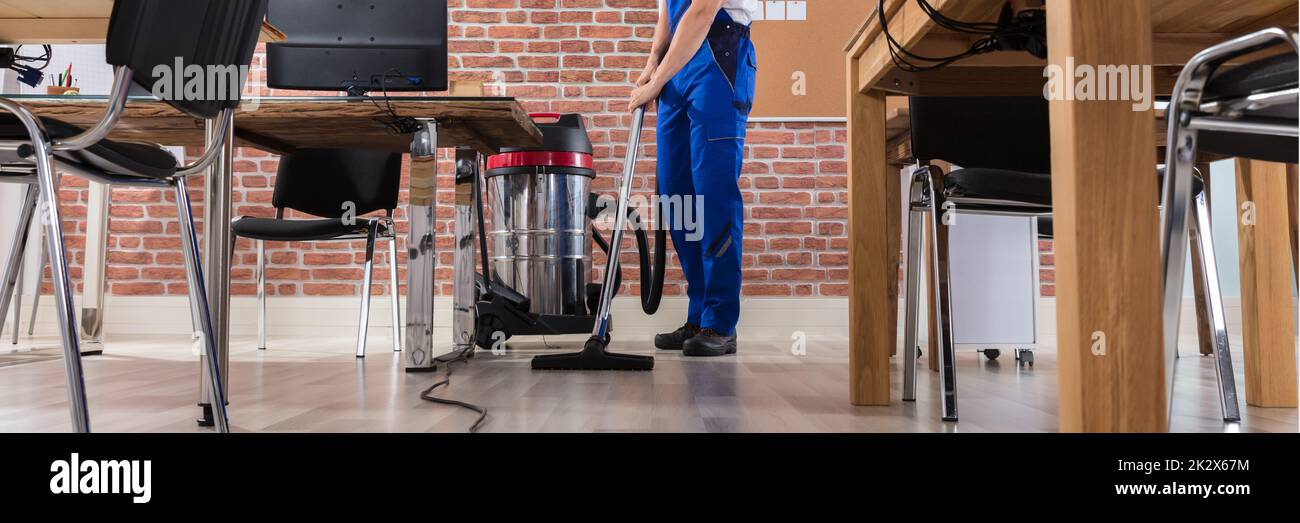 Janitor Cleaning Floor With Vacuum Cleaner Stock Photo - Alamy
