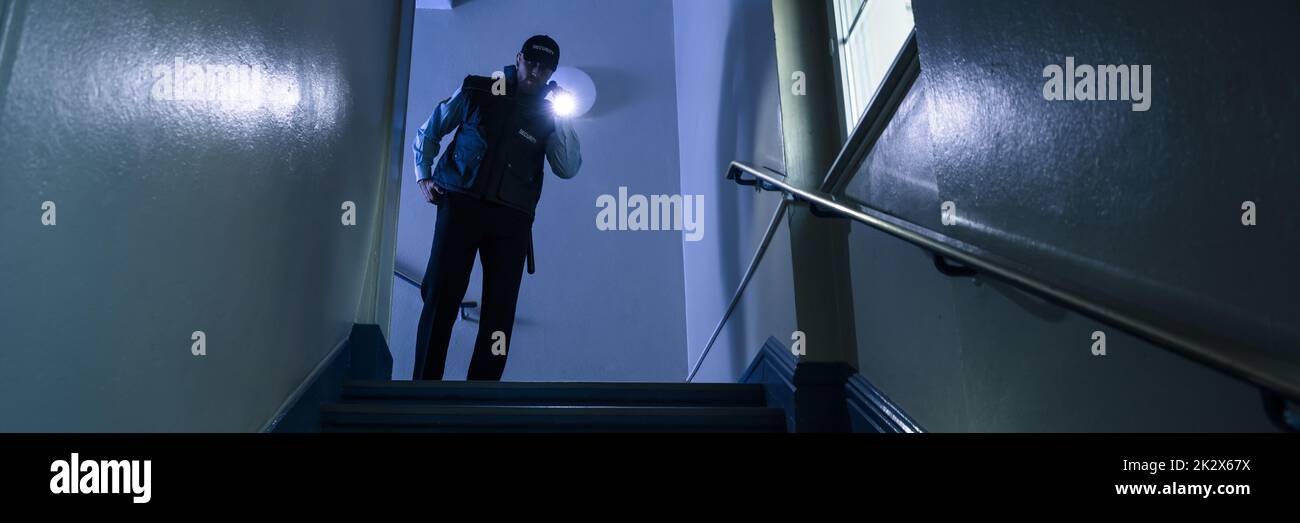 Security Guard With Flashlight Stock Photo - Alamy