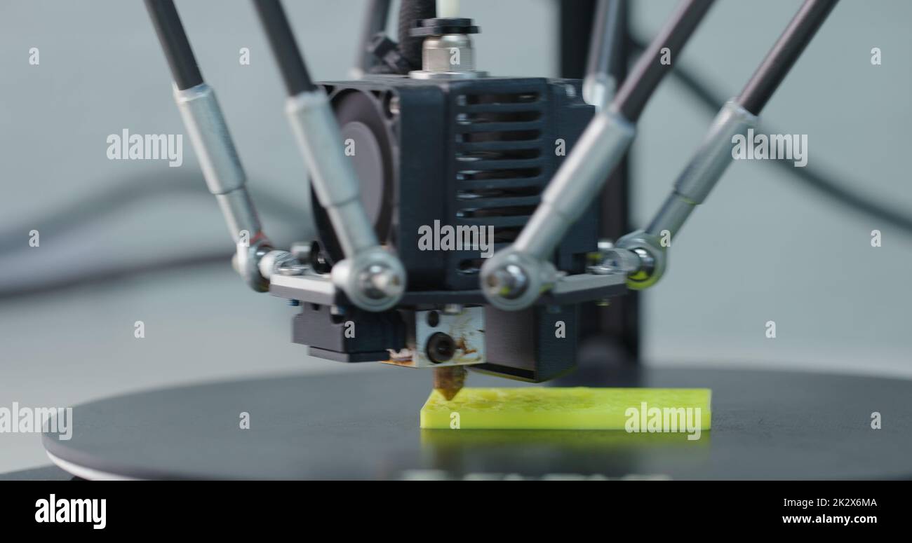 3D Printing Machine printing a piece of plastic Stock Photo - Alamy