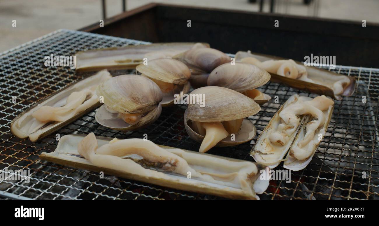 Fresh Short necked clam and Razor Clam on barbecue net Stock Photo - Alamy