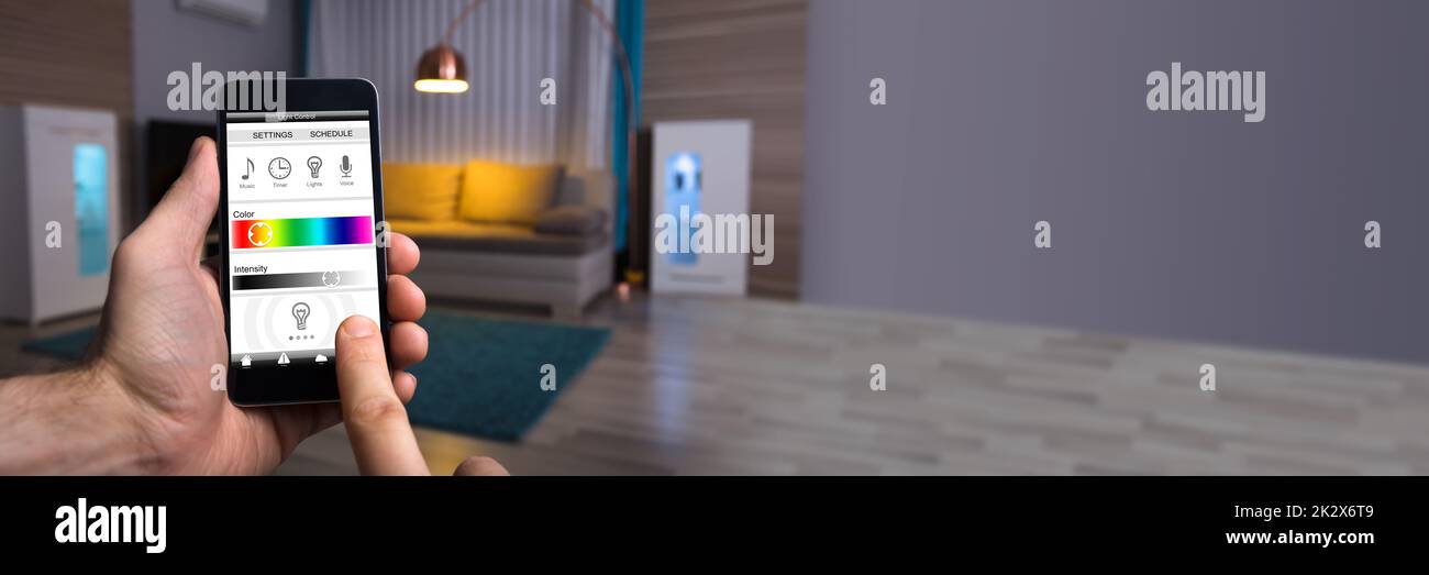 Human Hand Adjusting Electric Light Through Mobile Phone Stock Photo ...