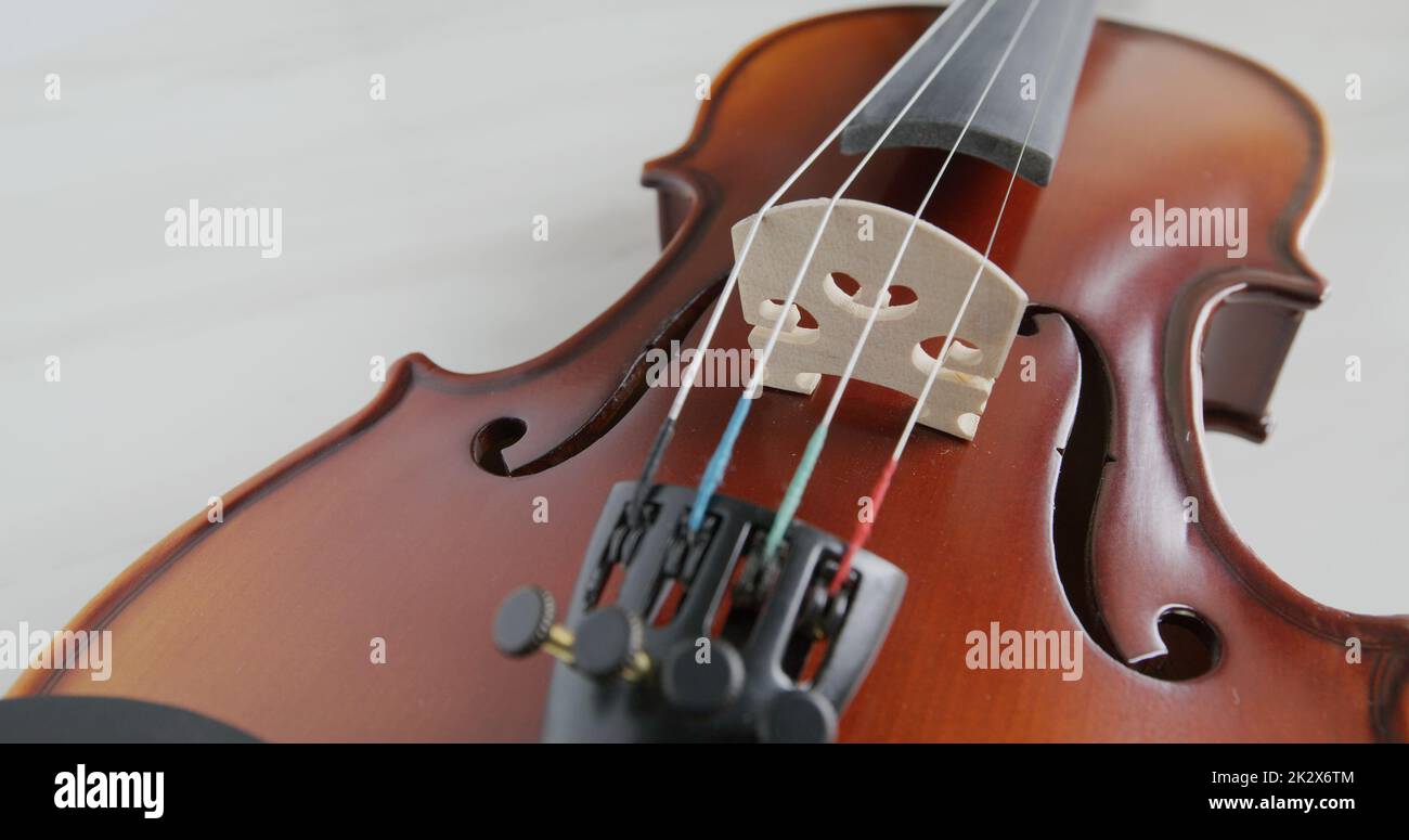 Violin string and bridge close up Stock Photo - Alamy