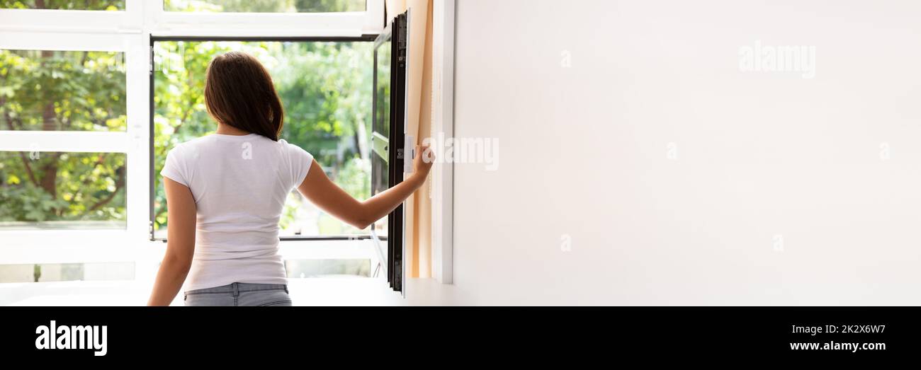 Woman Looking Through Window Stock Photo - Alamy
