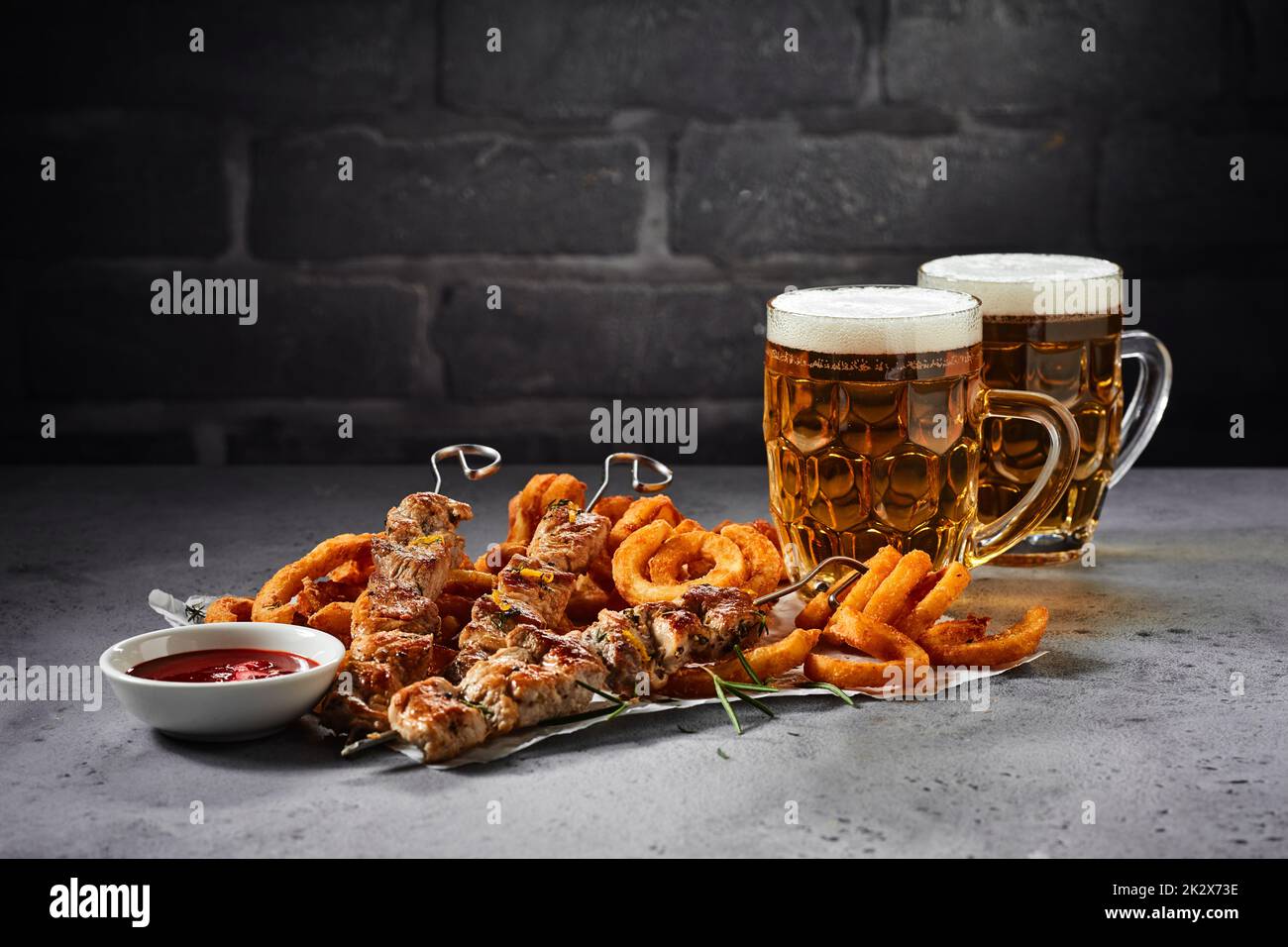 Delicious appetizers with ketchup and mugs of beer Stock Photo - Alamy