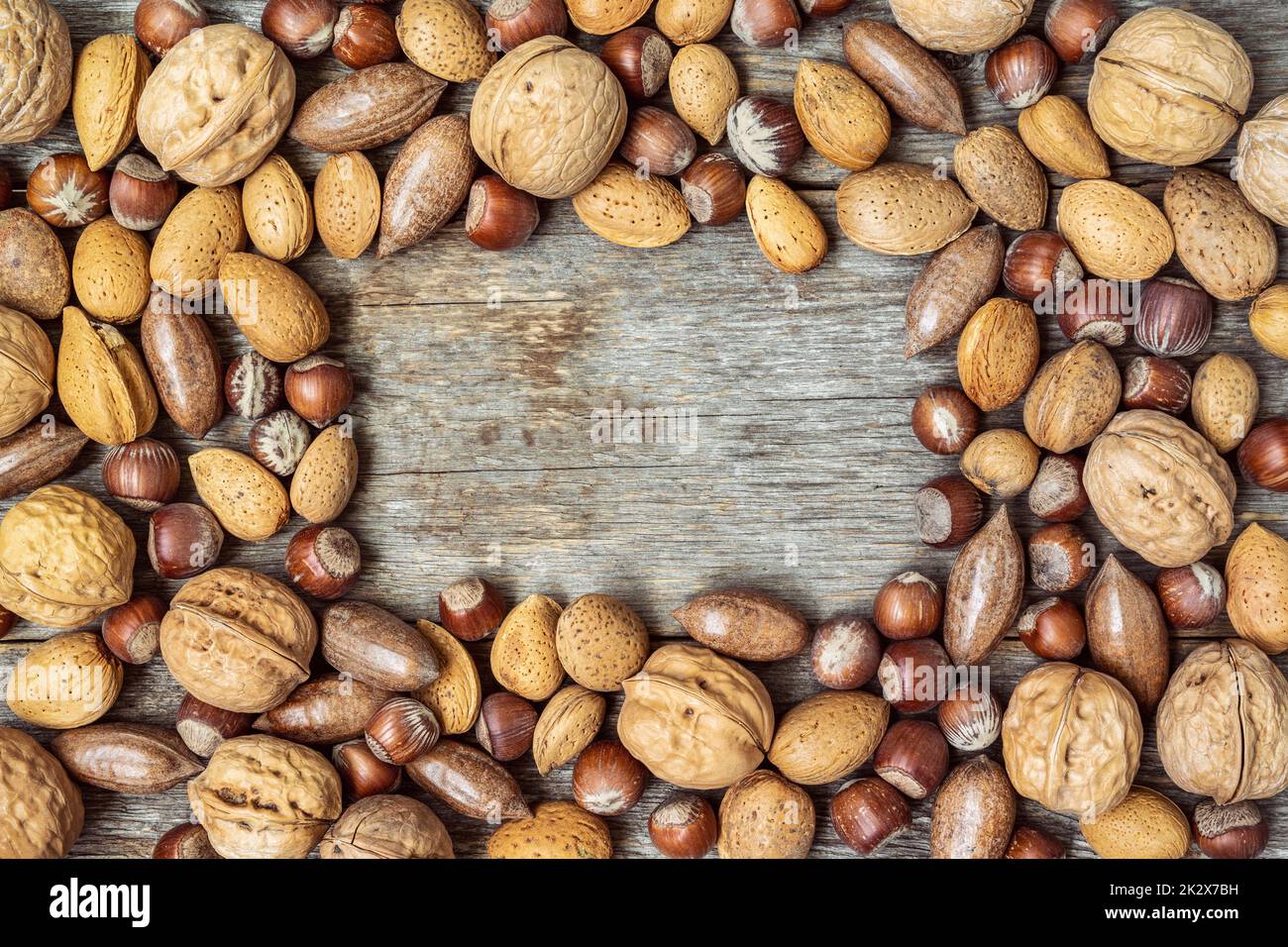 Frame for text in assorted nuts on wooden desk Stock Photo - Alamy