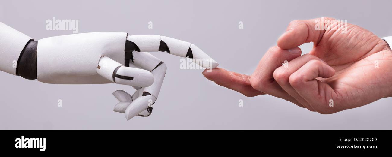 Robot Touching Human Finger Stock Photo - Alamy