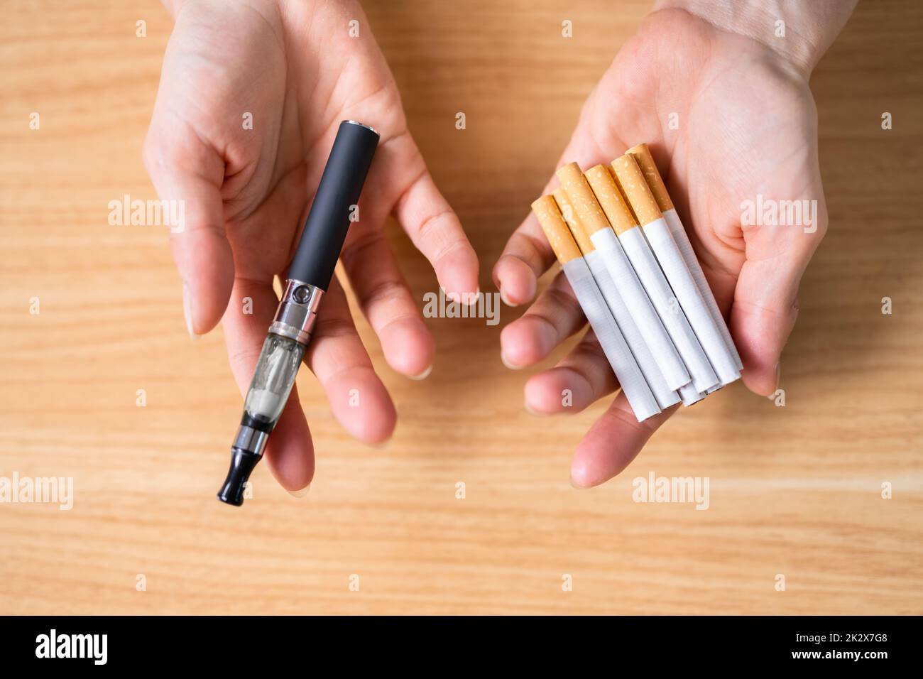 Woman Holding Vape And Tobacco Cigarettes Stock Photo - Alamy