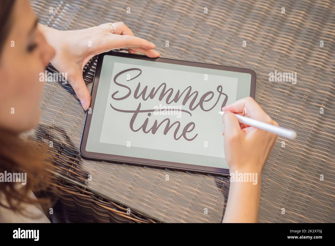 Calligrapher Young Woman writes phrase on digital tablet. Inscribing ...