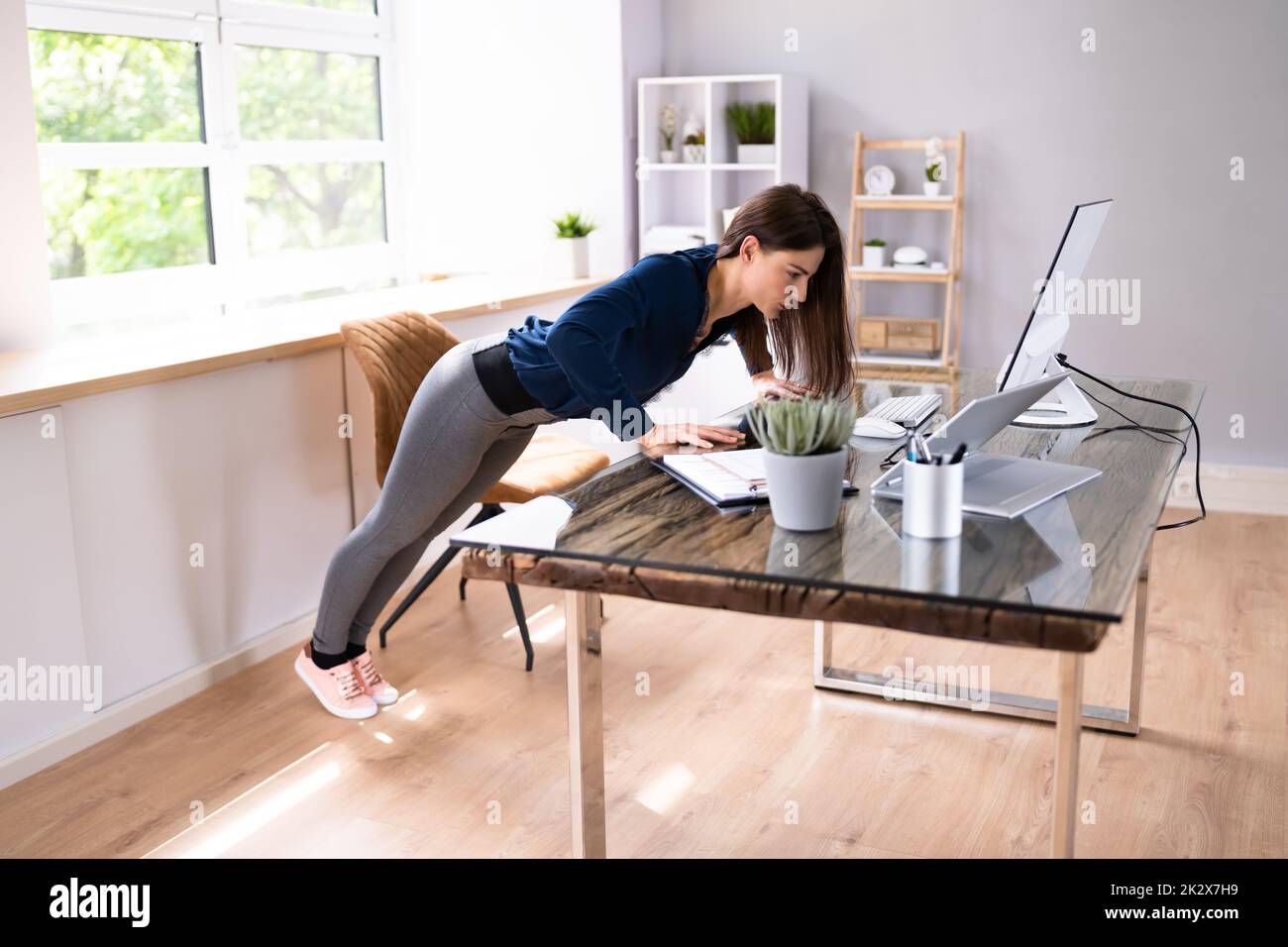 Businesswoman on office chair stretching hi-res stock photography and ...