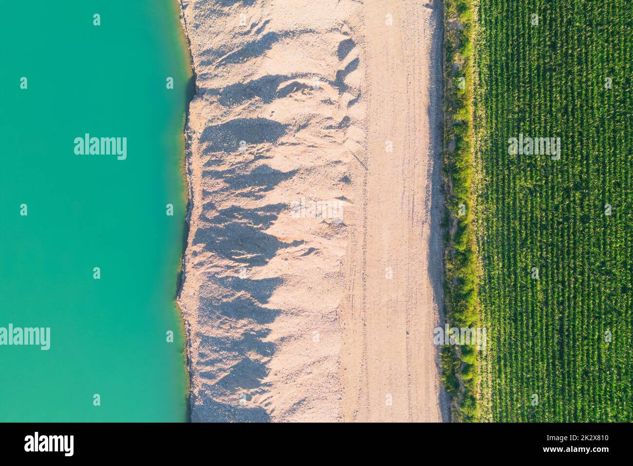 Landfill of the mined white fine aggregate between the turquoise lake ...