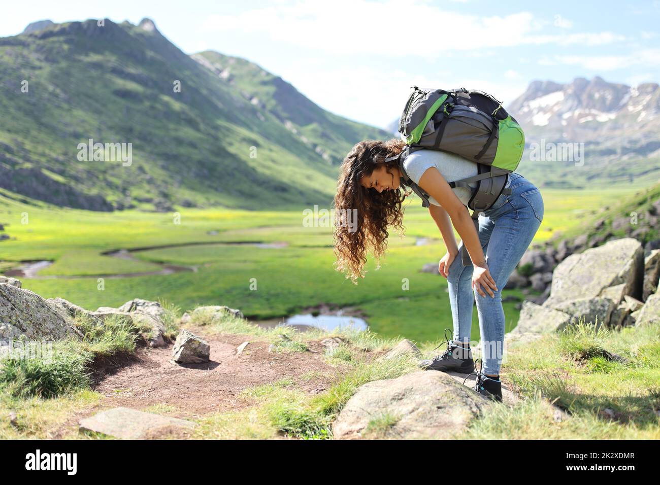 Exhausted hiker resting after climbing a mountain Stock Photo - Alamy