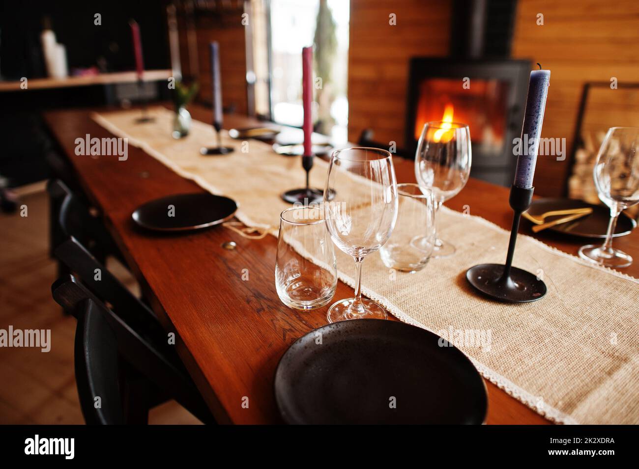 Table with paltes and candies in modern wooden house with fireplace ...