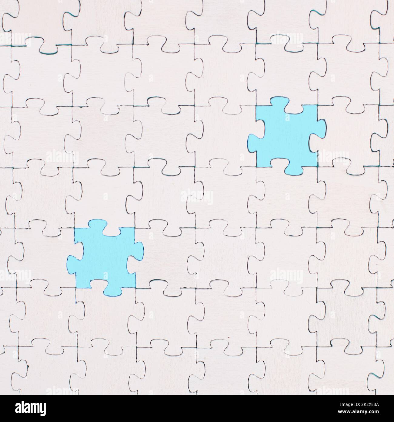 White jigsaw on a blue background, missing parts, working together as a ...