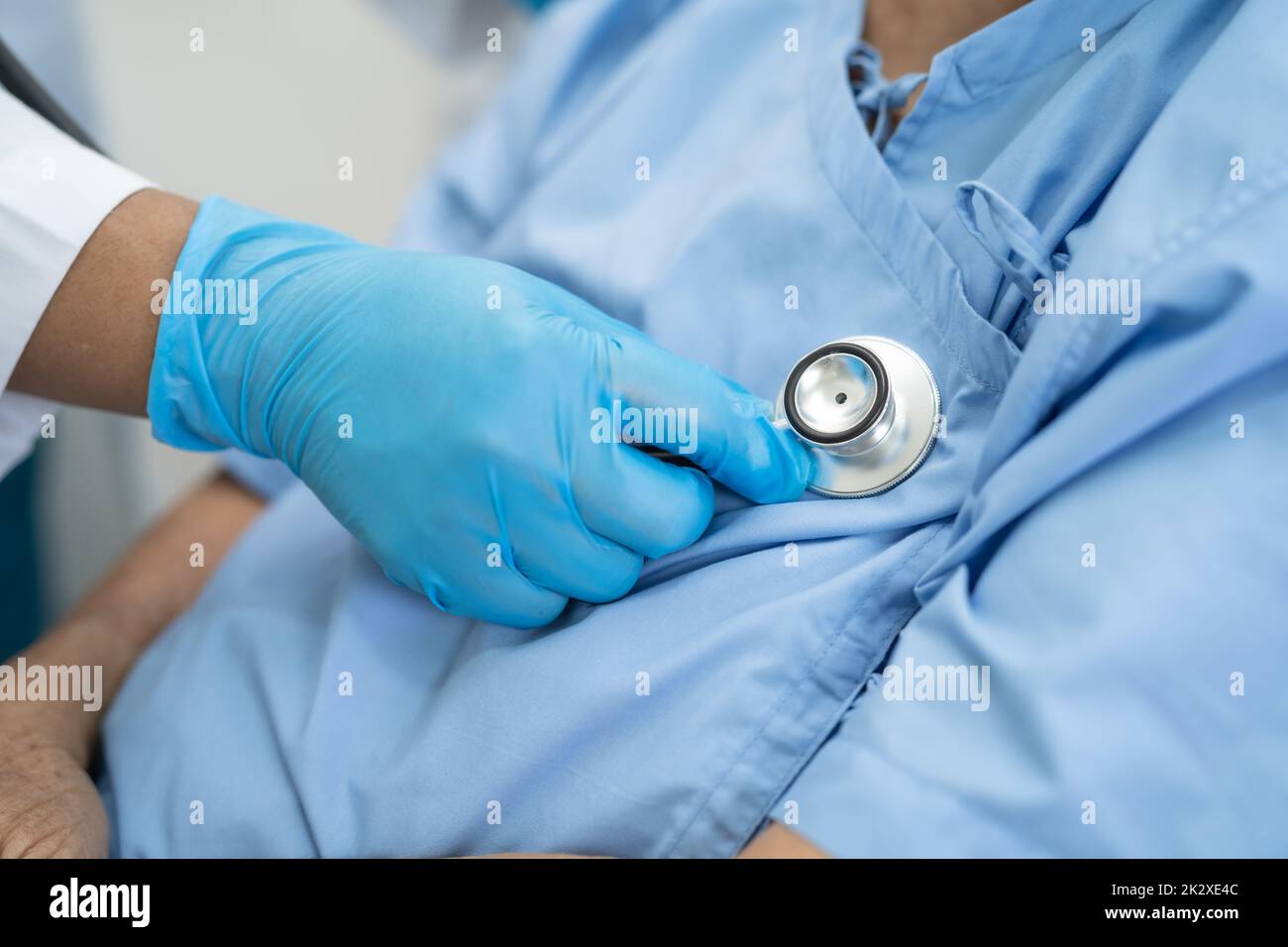 Doctor with ppe suit help Asian senior or elderly old lady woman ...