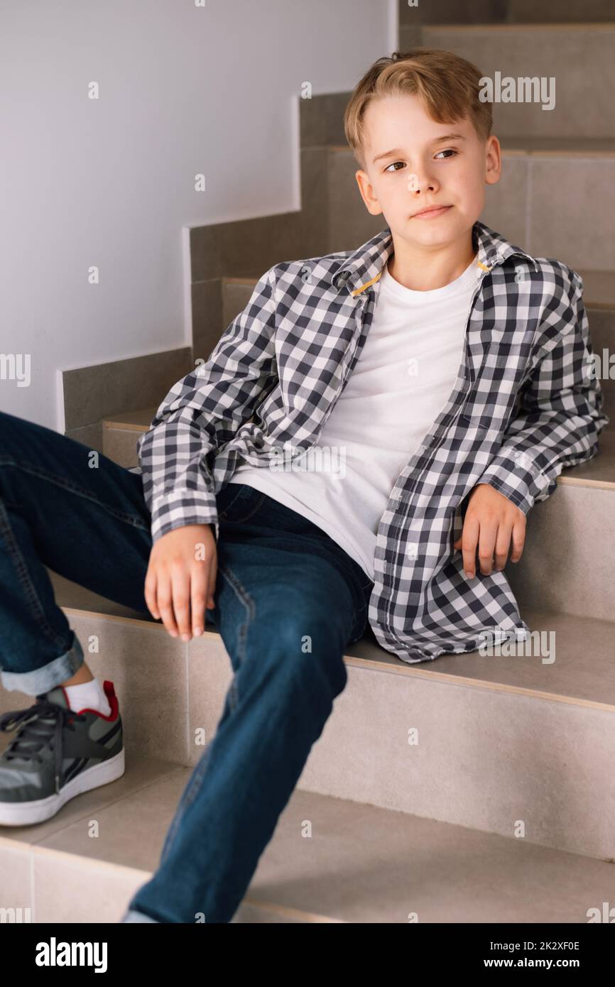 Handsome young smiling young teenage man sitting on steps indoors Stock ... Handsome young smiling young teenage man sitting on steps indoors Stock ...