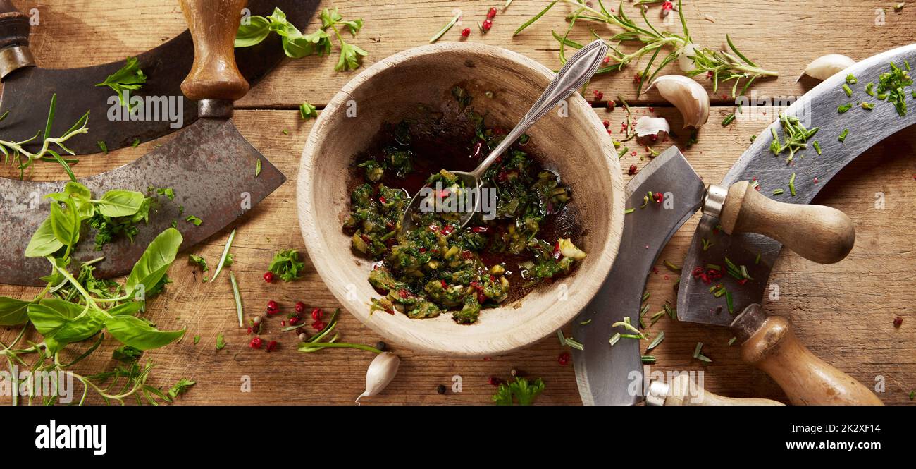 Grinded herbs near mezzaluna knives Stock Photo - Alamy