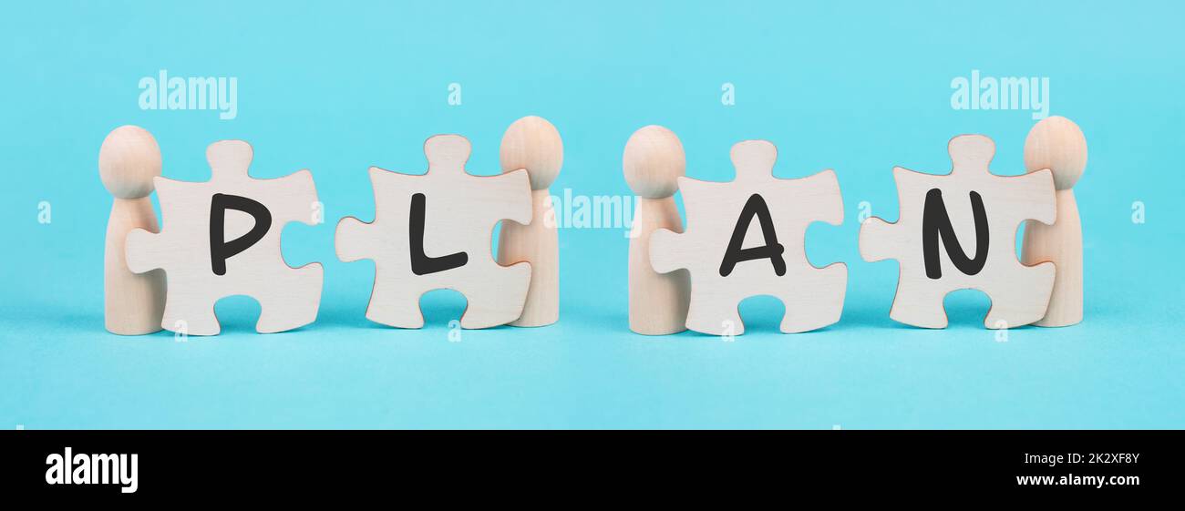 The word plan is standing on puzzle pieces, connect the parts together, corporate in teamwork ...