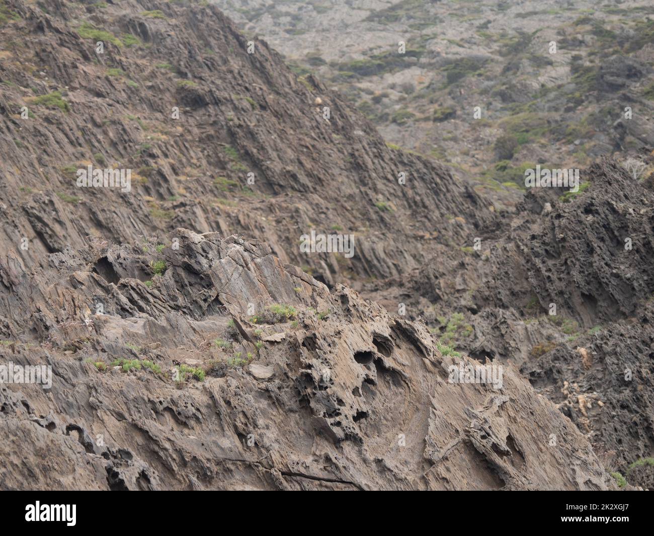 An aerial view of cave of hell under blue bright sky in Cap de Creus ...