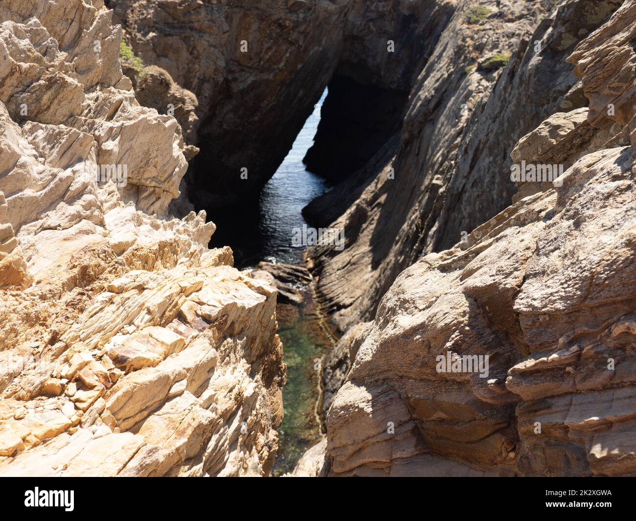 An aerial view of cave of hell surrounded by water in Cap de Creus ...