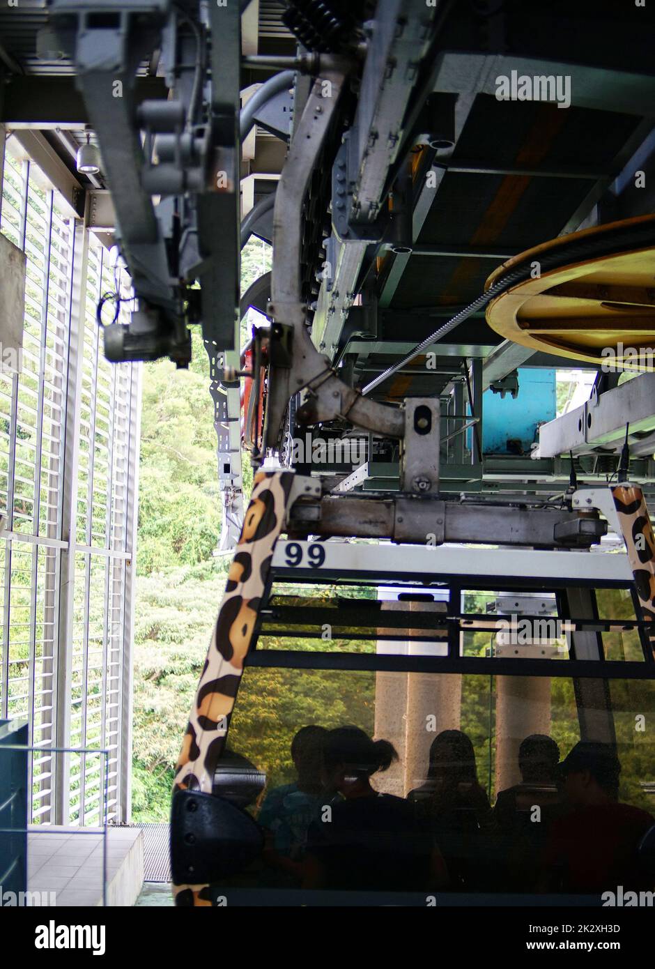A vertical shot of a gondola lift ready to take off at the Maokong ...