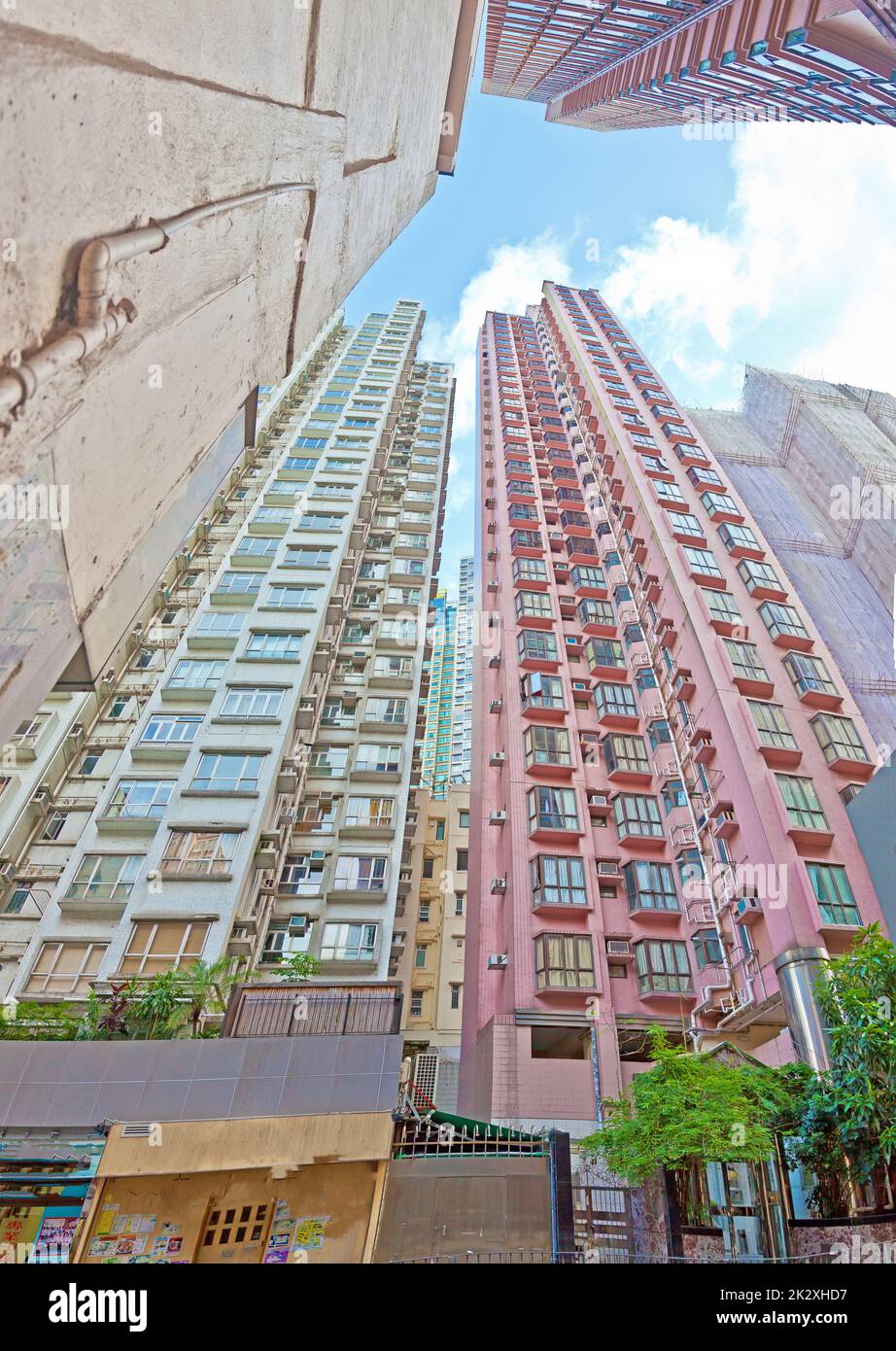 Vertical view up along skyscraper facades from a narrow street in Hong ...