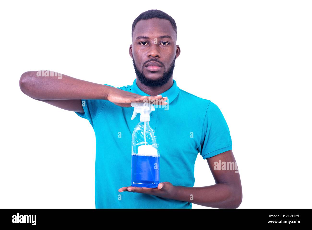 handsome serious young man wearing blue t-shirt, holding bottle of ...