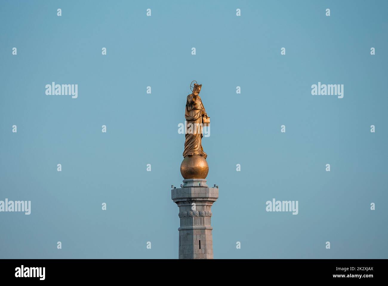 Low angle view of beautiful Statue of Golden Madonna with blue sky in ...