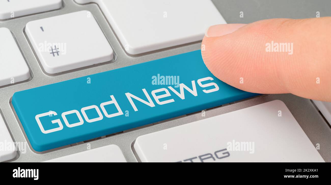 A keyboard with a blue labeled button - Good news Stock Photo - Alamy