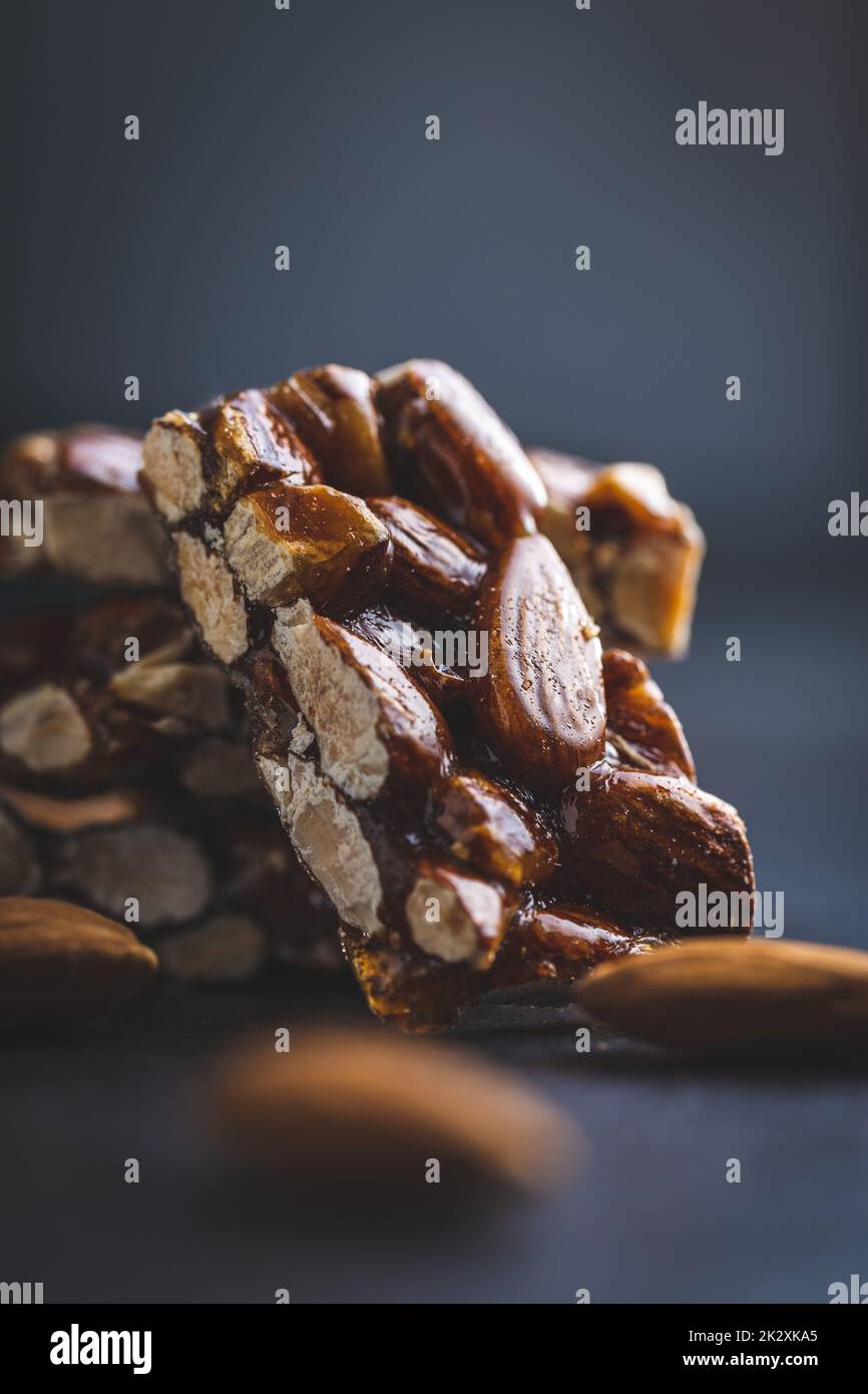 Sweet mini almond bars on black table Stock Photo - Alamy